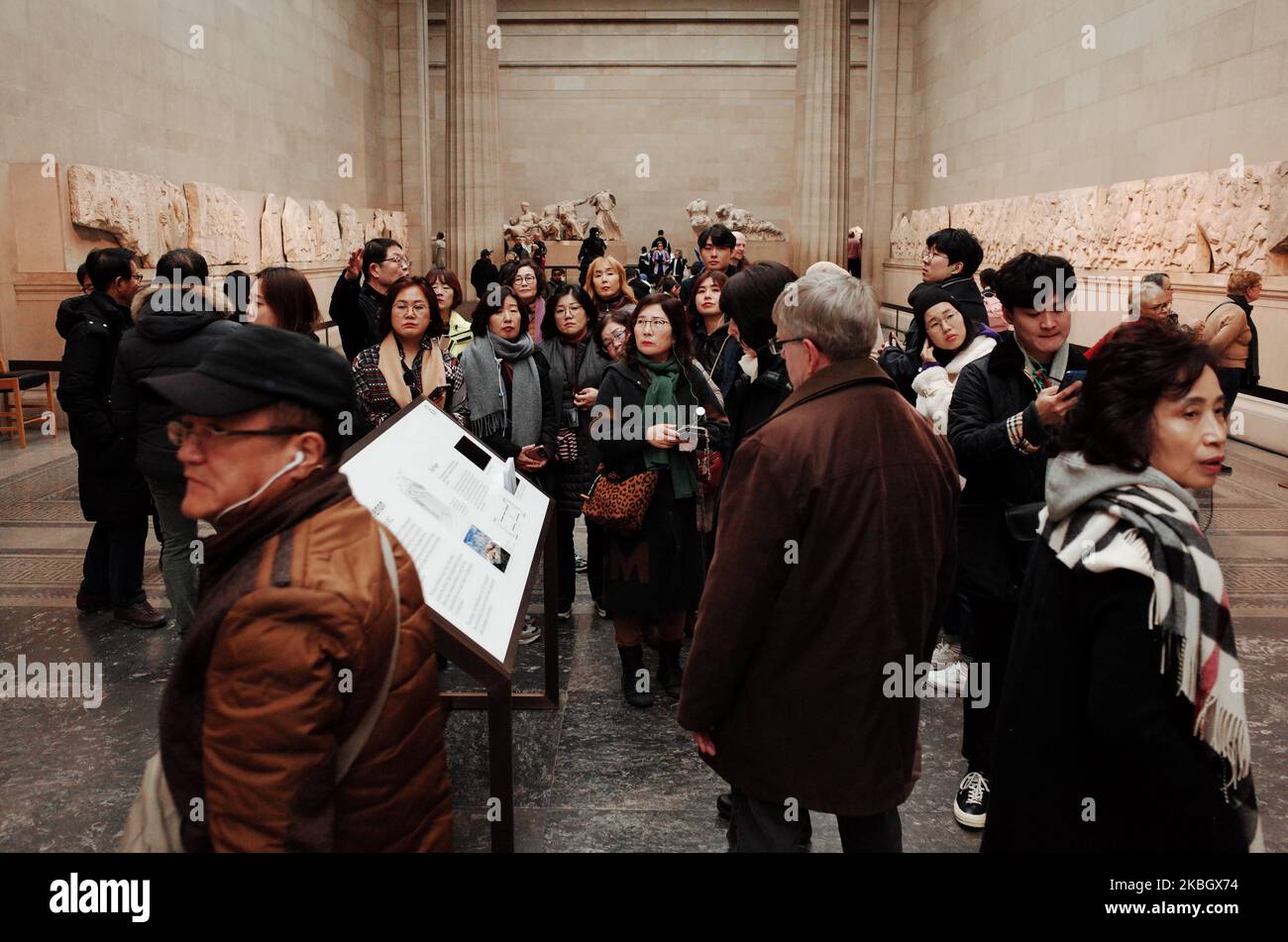 Tourists look at the Parthenon Sculptures exhibit in the British Museum ...