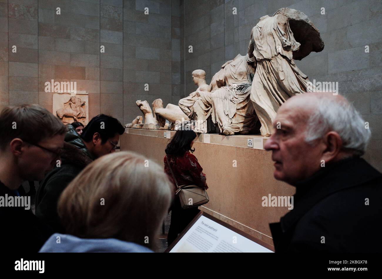 Visitors look at a section of the Parthenon Sculptures exhibit in the ...