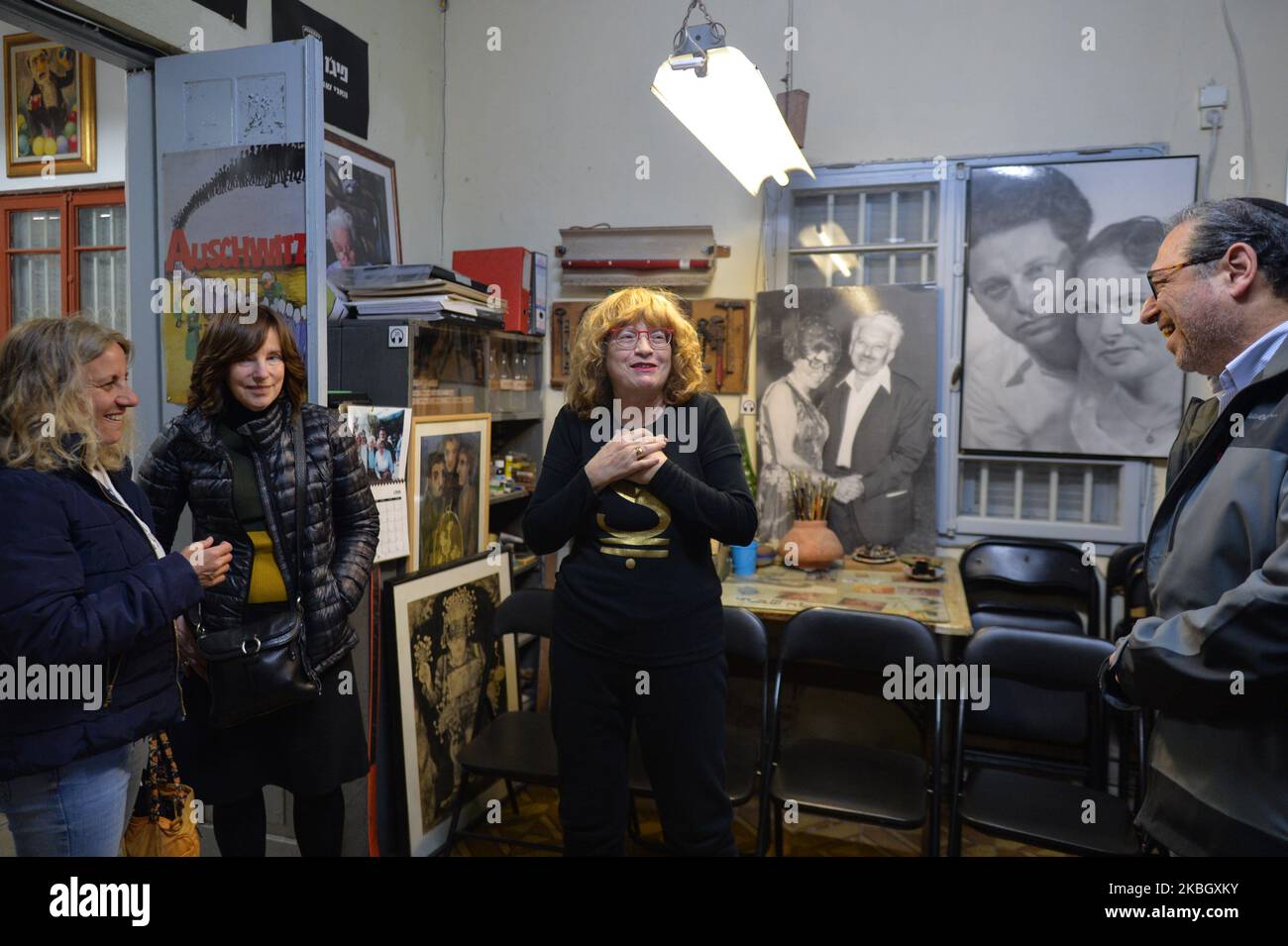 Clila Bau-Cohen (Center) explains her parents story to visitors inside ...