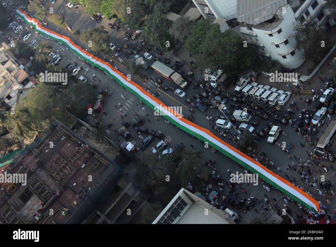 People hold an Indian national flag during a rally in support of the ...