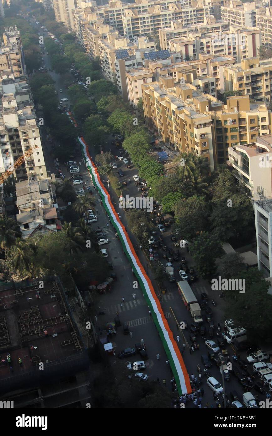 People hold an Indian national flag during a rally in support of the ...