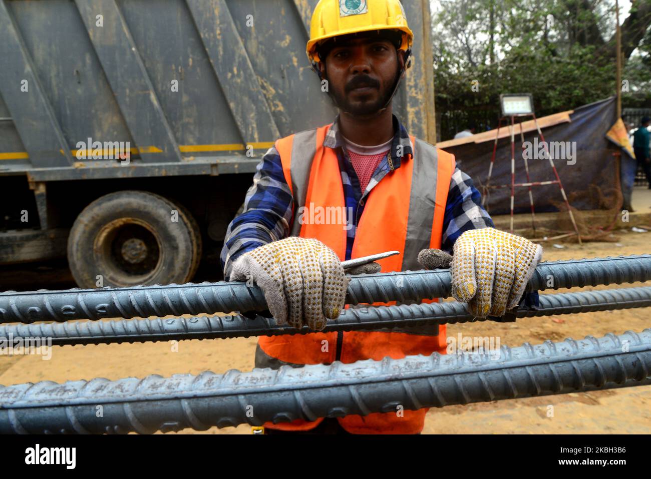 Bangladeshi workers preparing reinforcing steel at a construction site ...