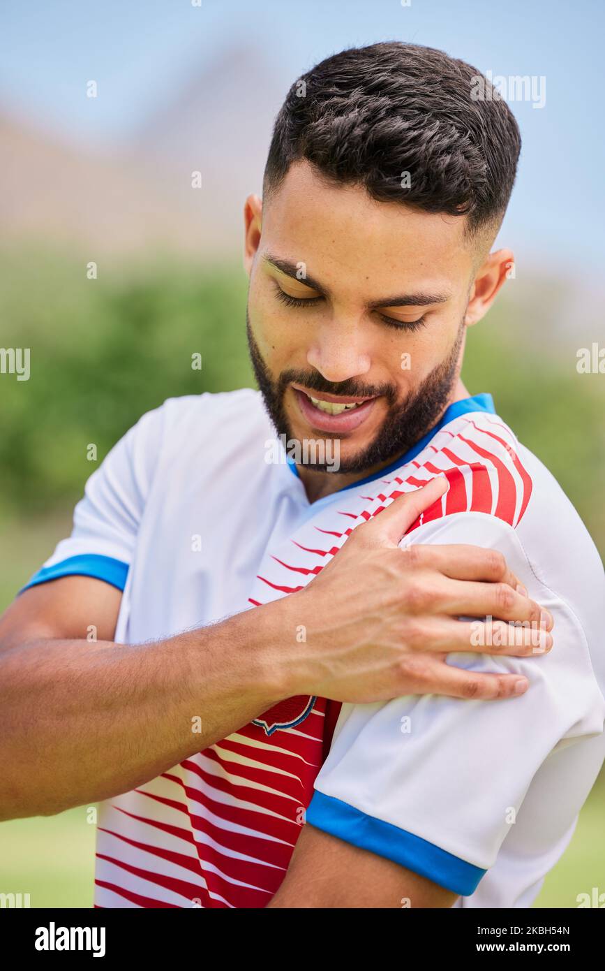 Sports, football and man with shoulder pain, injury or training ...