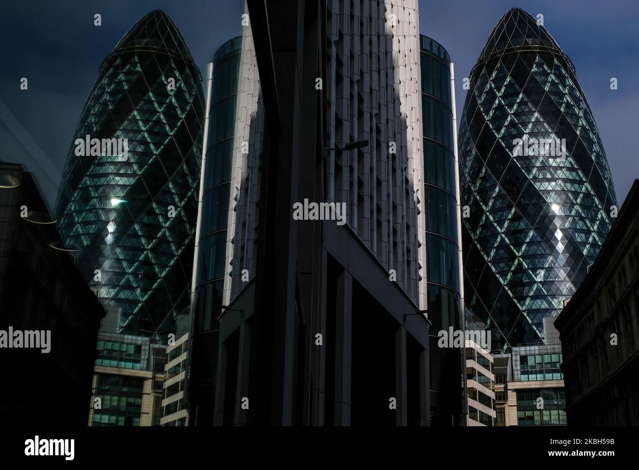 St. Mary Axe skyscraper, commonly known as The Gherkin, is reflected on ...