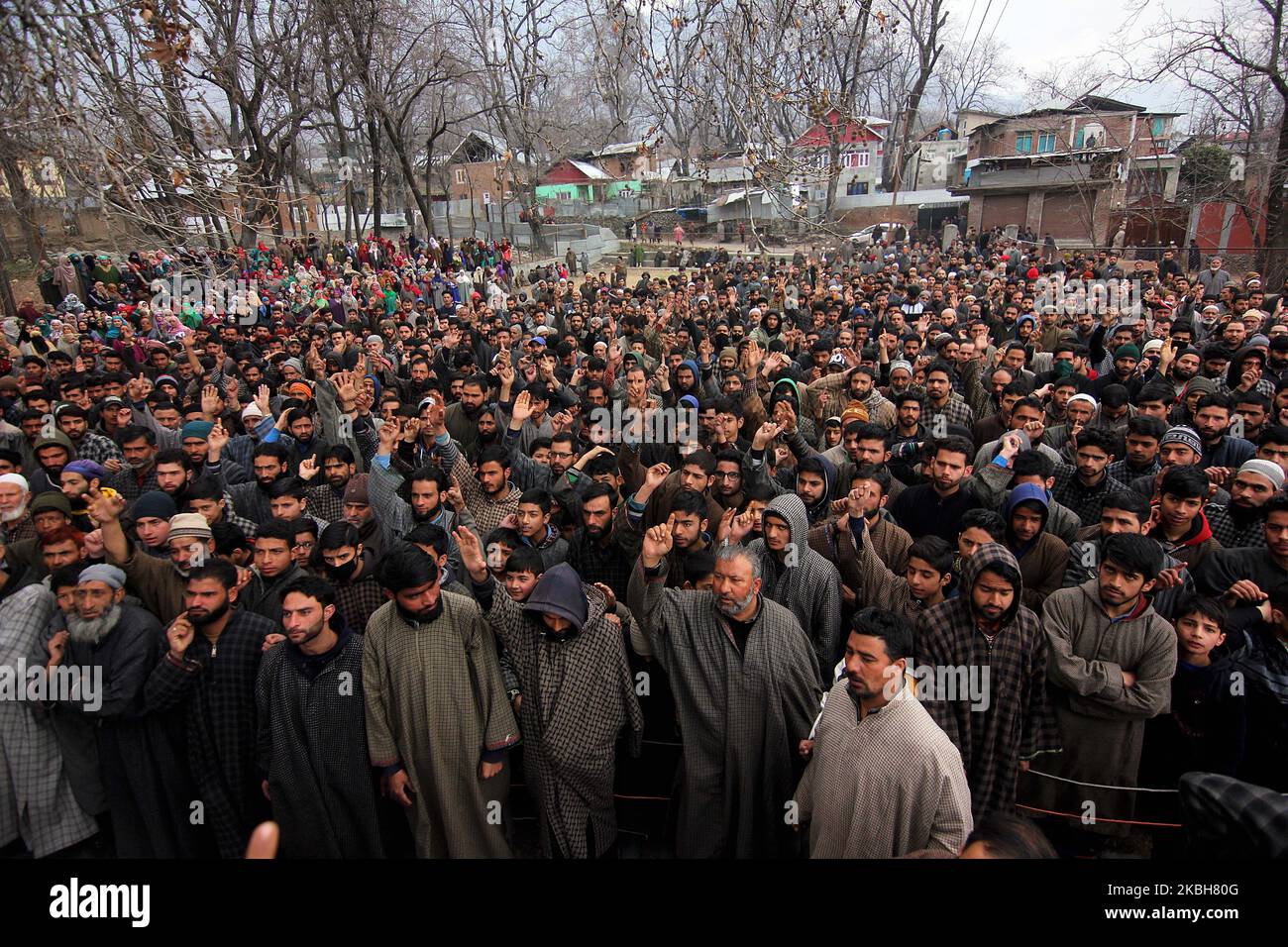 Villagers shout slogans as they attend the funeral of a local rebel ...