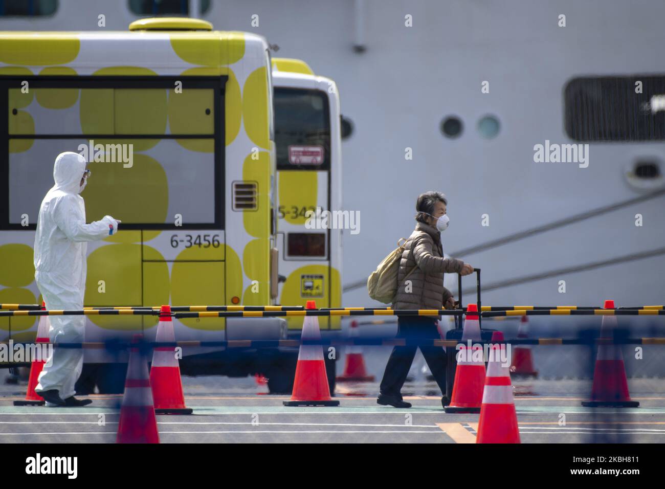 Passengers walk out from the cruise ship Diamond Princess at Daikoku ...