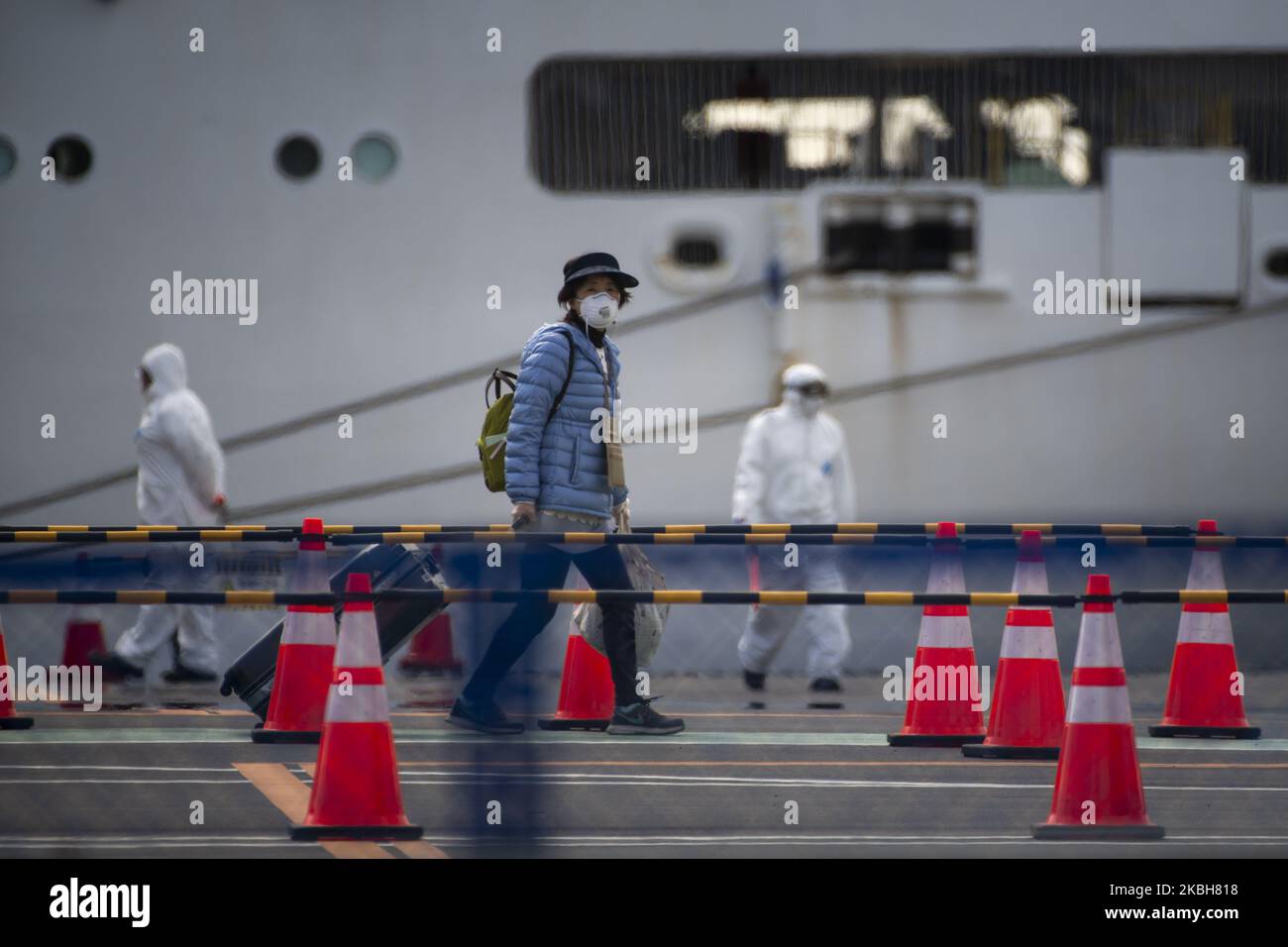 Passengers walk out from the cruise ship Diamond Princess at Daikoku ...