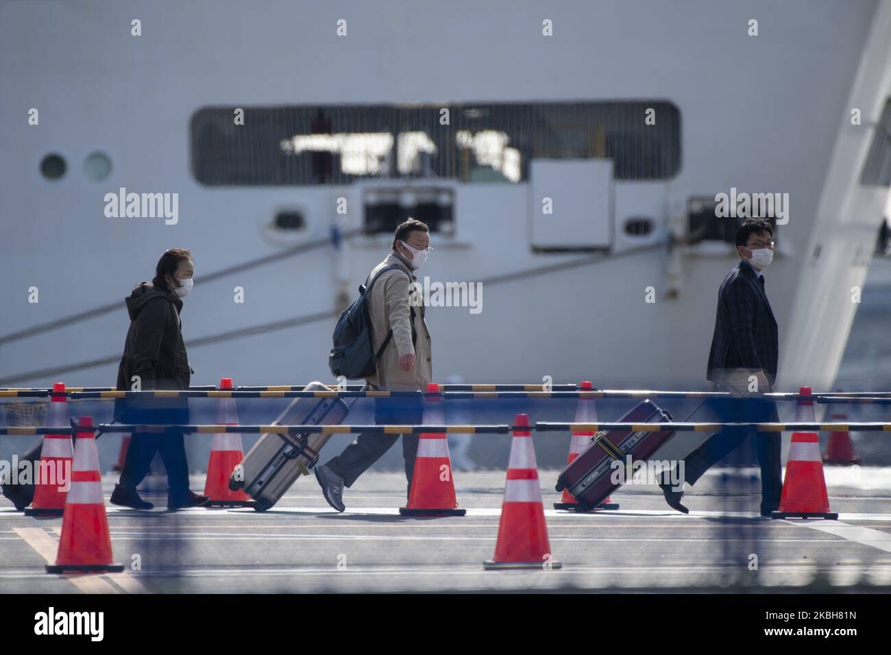 Passengers walk out from the cruise ship Diamond Princess at Daikoku ...