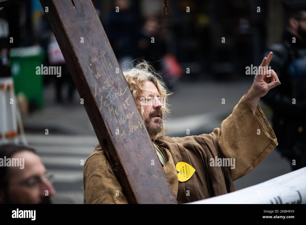 A guy disguised in Jesus carrying the cross of Jesus during a ...