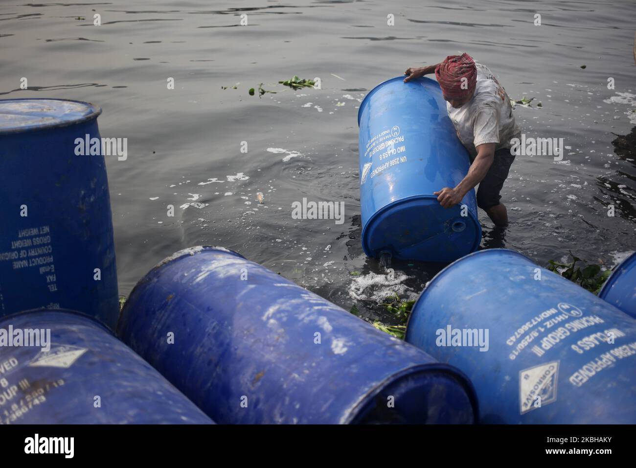 A Worker clean chemical contaminated drums in the river Buriganga in ...