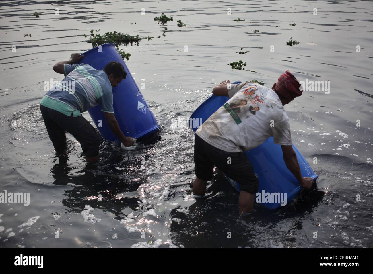 Workers clean chemical contaminated drums in the river Buriganga in ...
