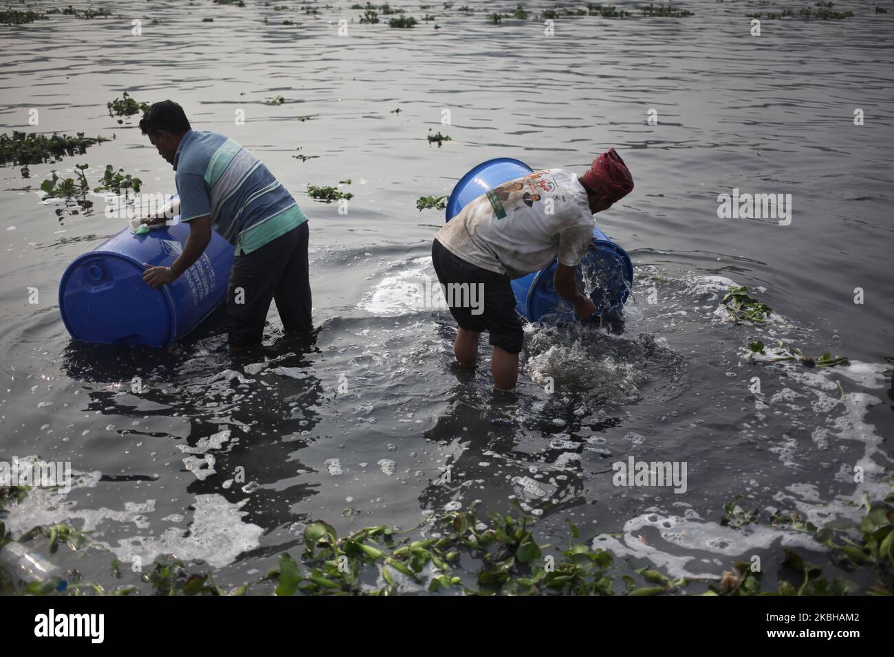 Workers clean chemical contaminated drums in the river Buriganga in ...
