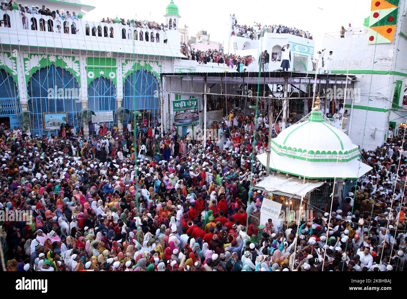 Indian Muslim devotee take part during the flag hoisting ceremony as ...