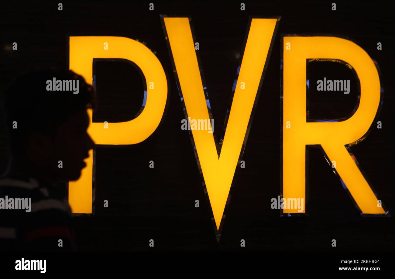 A man walks past logo of PVR Cinemas at a mall on February 20, 2020 in ...