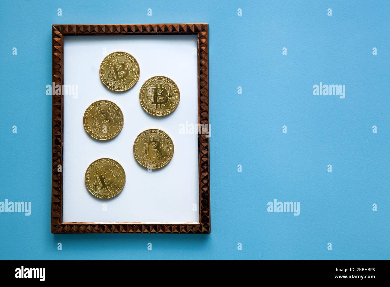 Bitcoins in a frame on a blue background. Economy, finance and exchange ...