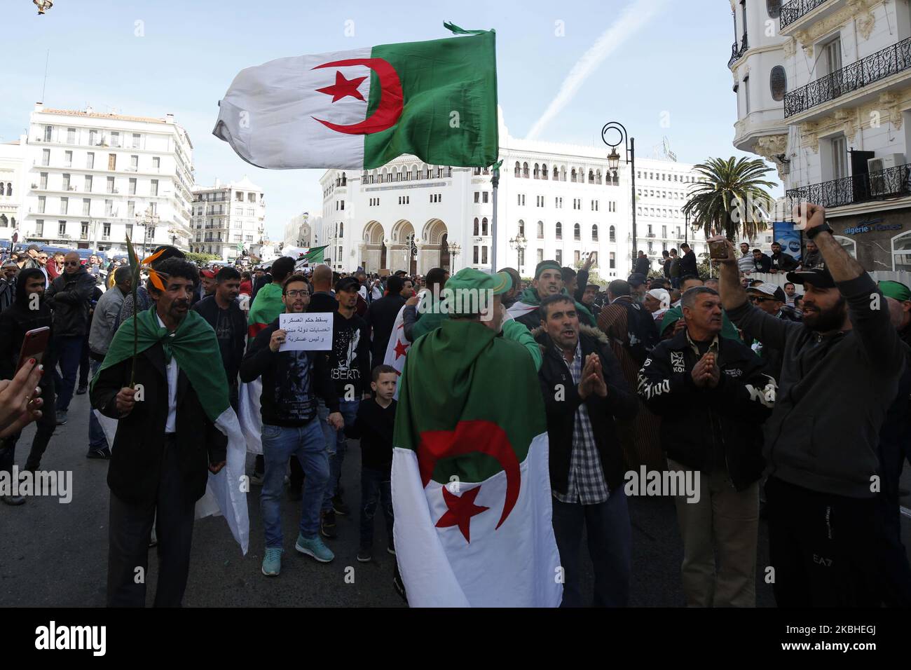 Algerian protesters wave the national flag during their weekly anti ...