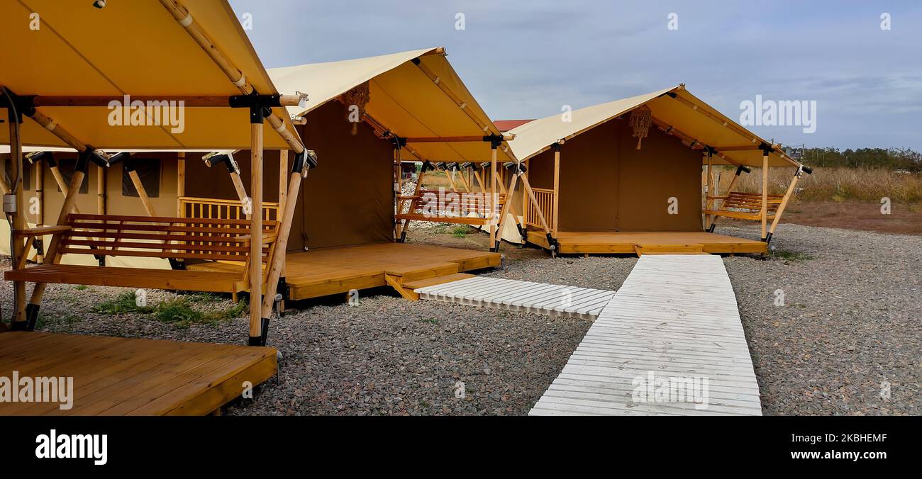 Large wooden framed tents with wooden walkways in a campground Stock ...