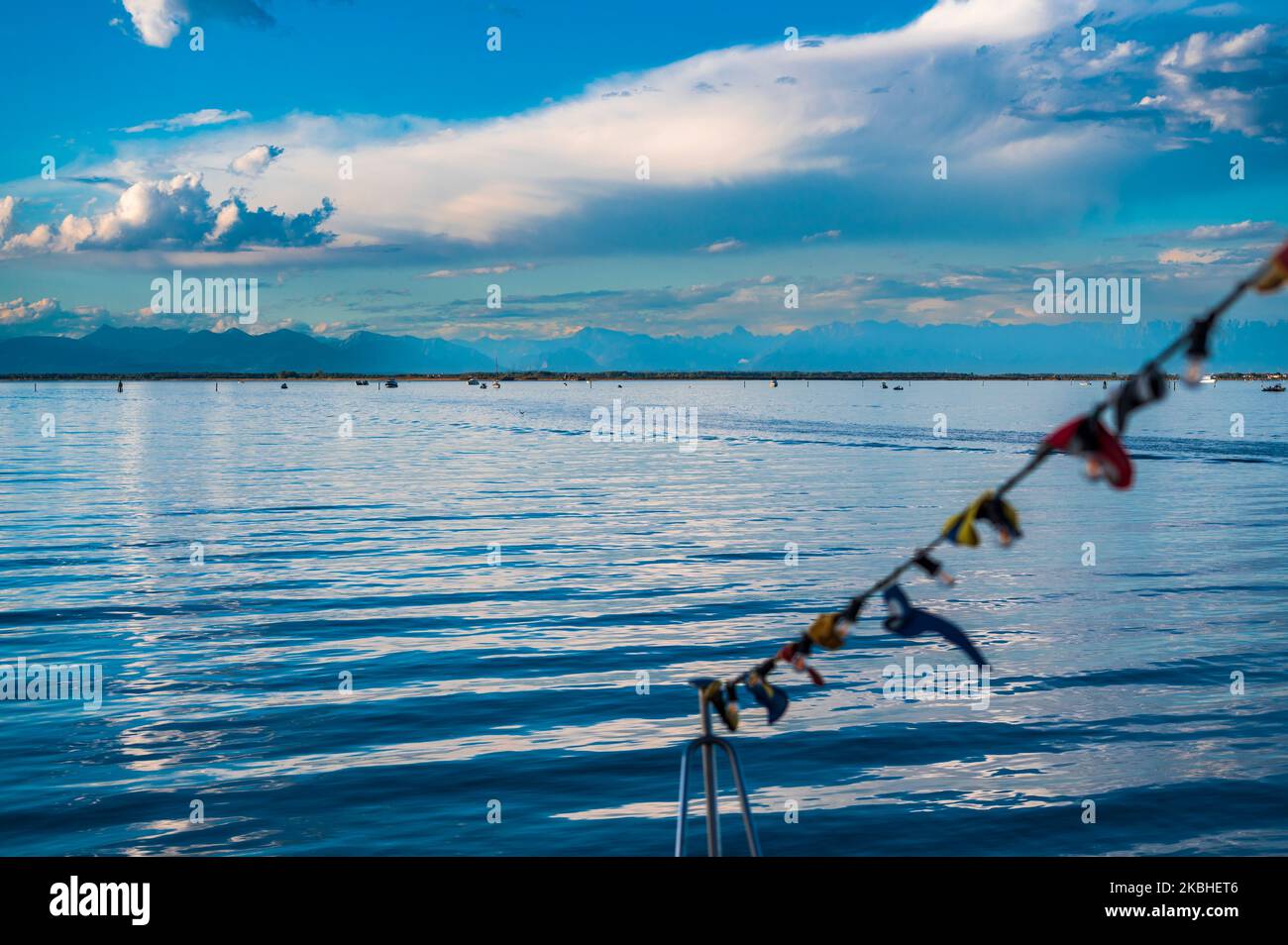 Towards the sunset. Marano lagoon late summer colors. Clouds and sun ...