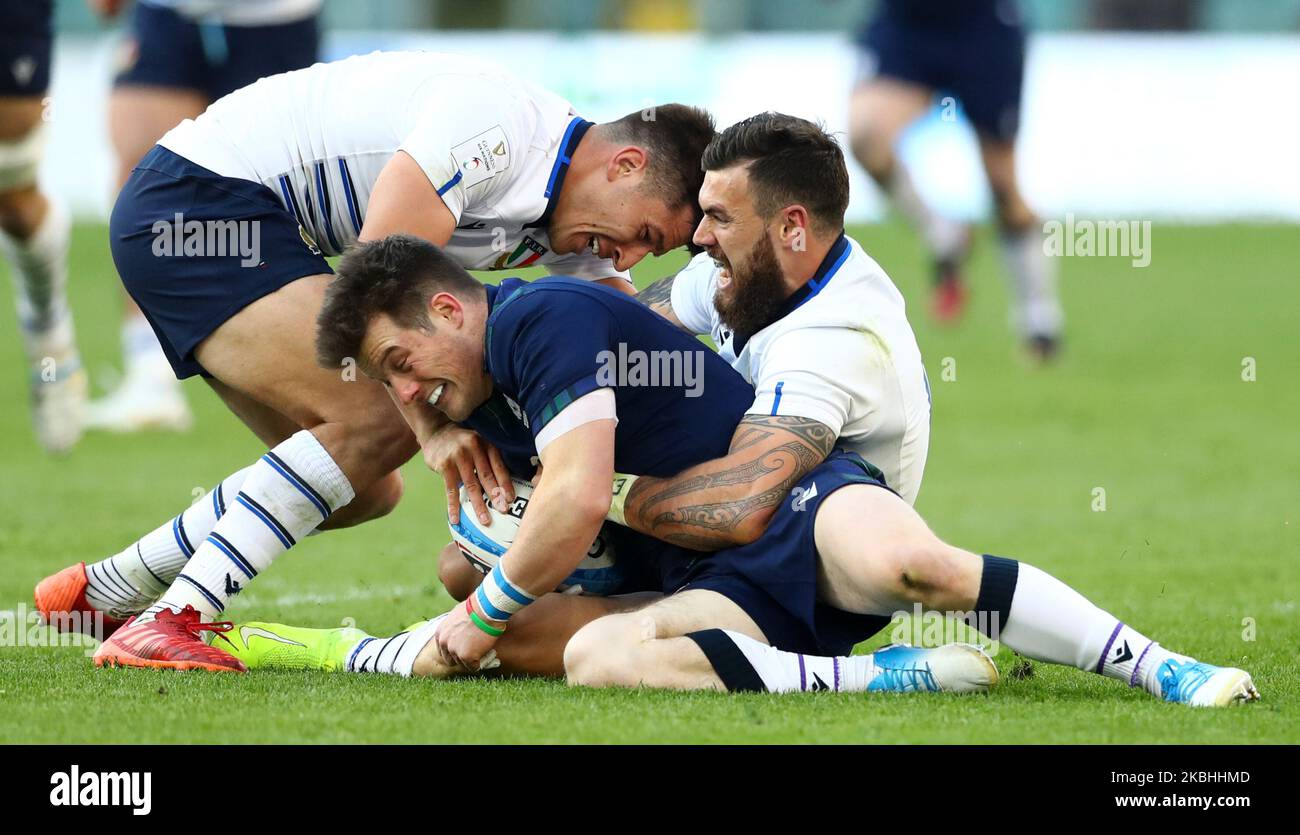 George Horne of Scotland tackled by Tommaso Allan and Jayden Hayward of ...