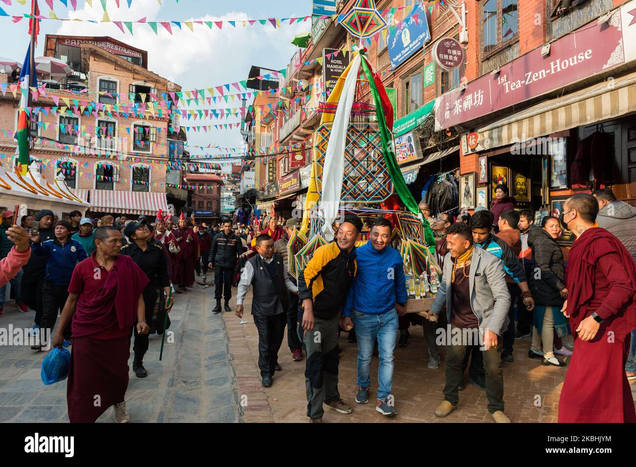 Buddhist devotees carry an effigy as they walk in a procession around ...