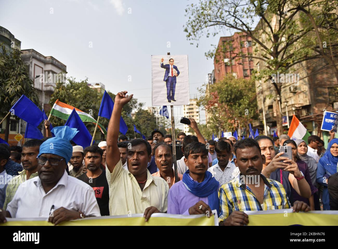 Members of Bhim Army, West Bengal, hold posters, banners and placards ...