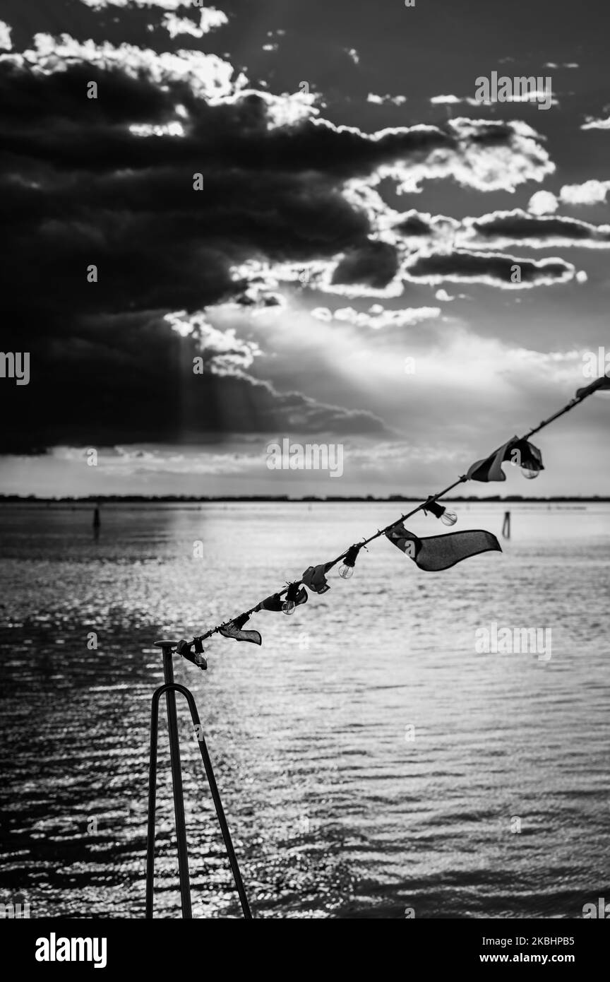 Towards the sunset. Marano lagoon late summer colors. Clouds and sun ...