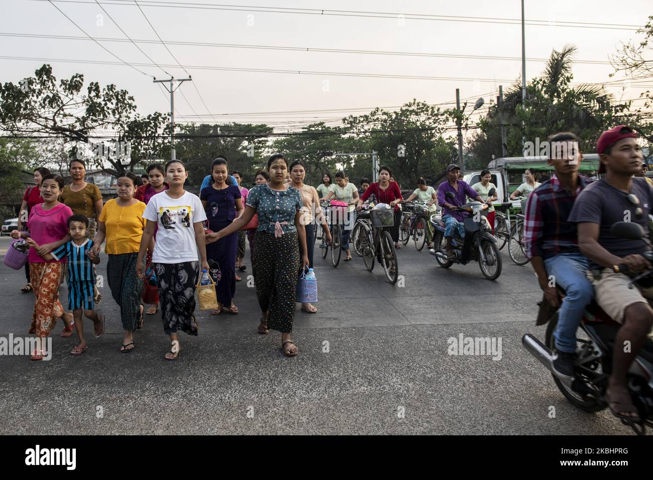 Factory workers leave their factories during rush hour in Hlaing Thar ...