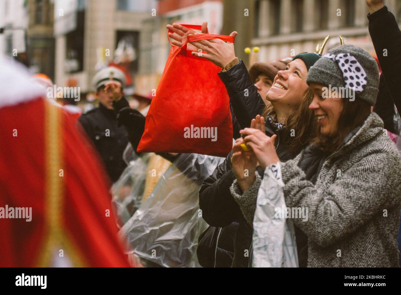 Visitors tries to catch the candy during the Rose Monday parade on ...