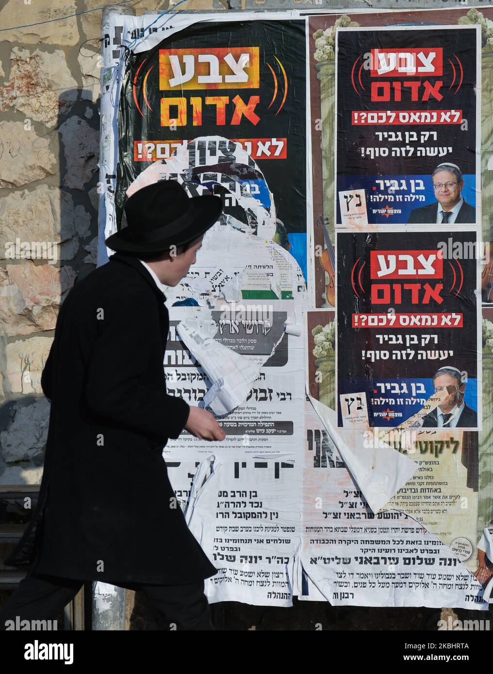 An Ultra-Orthodox Jew walks past an election campaign poster for far ...
