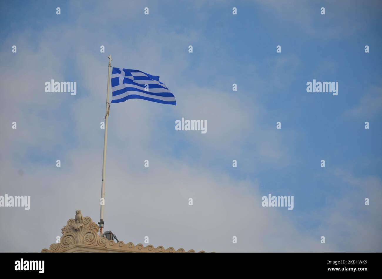 A Greek flag flying on top of the university building in Athens , on 25 ...