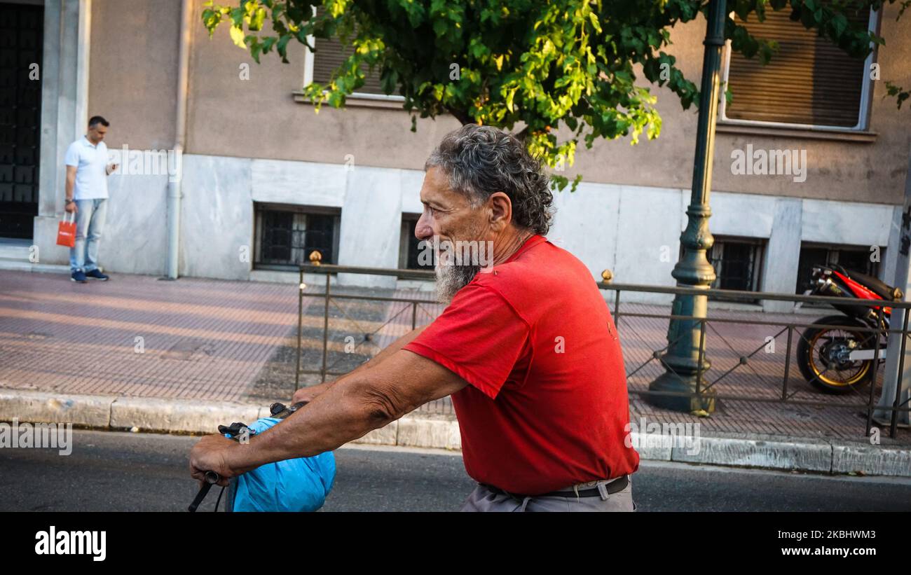 A man makes a journey through the streets of Athens , Greece on 25 ...