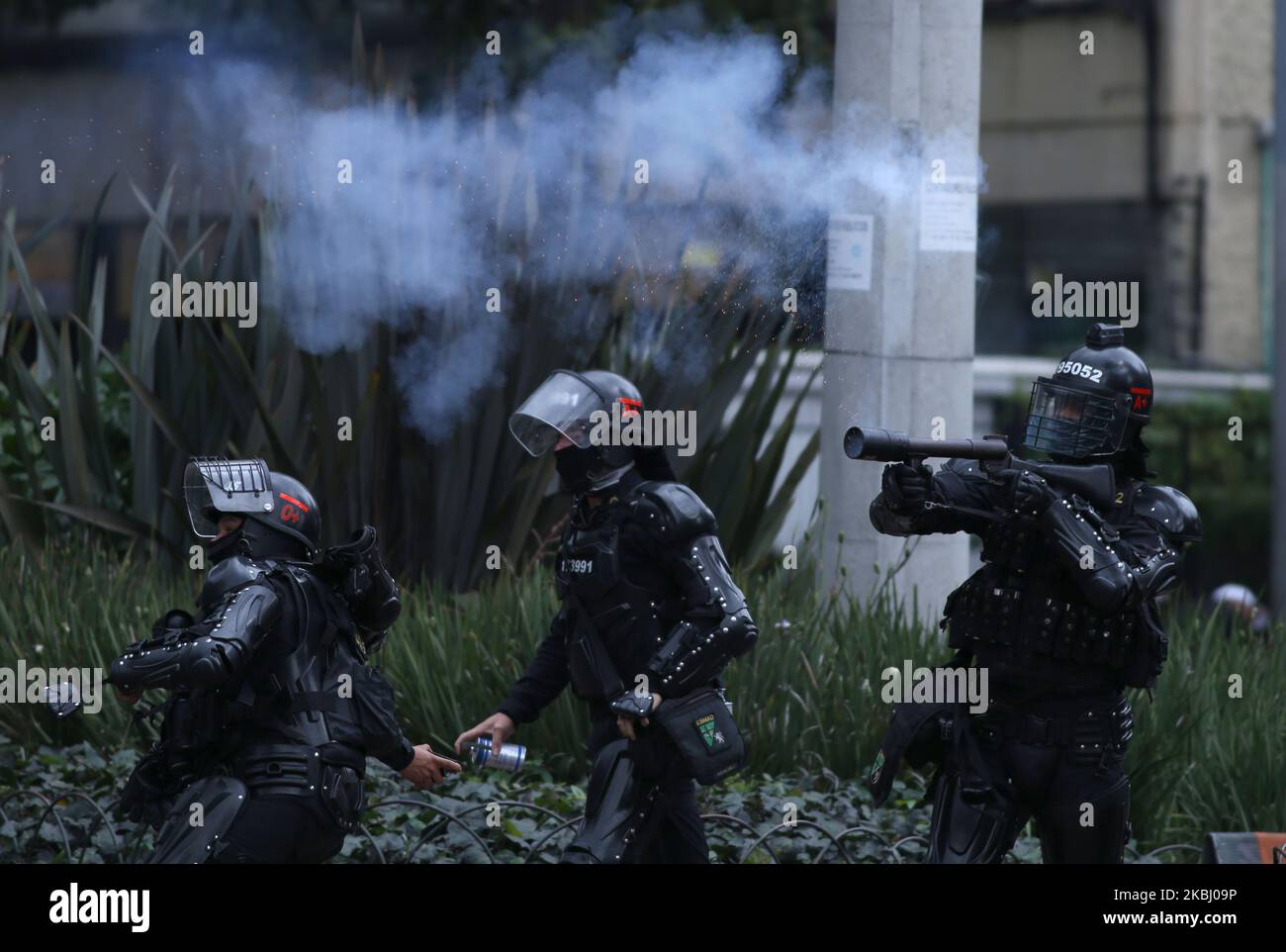 Some agents trying to disperse hooded men in celebration of the 21st ...