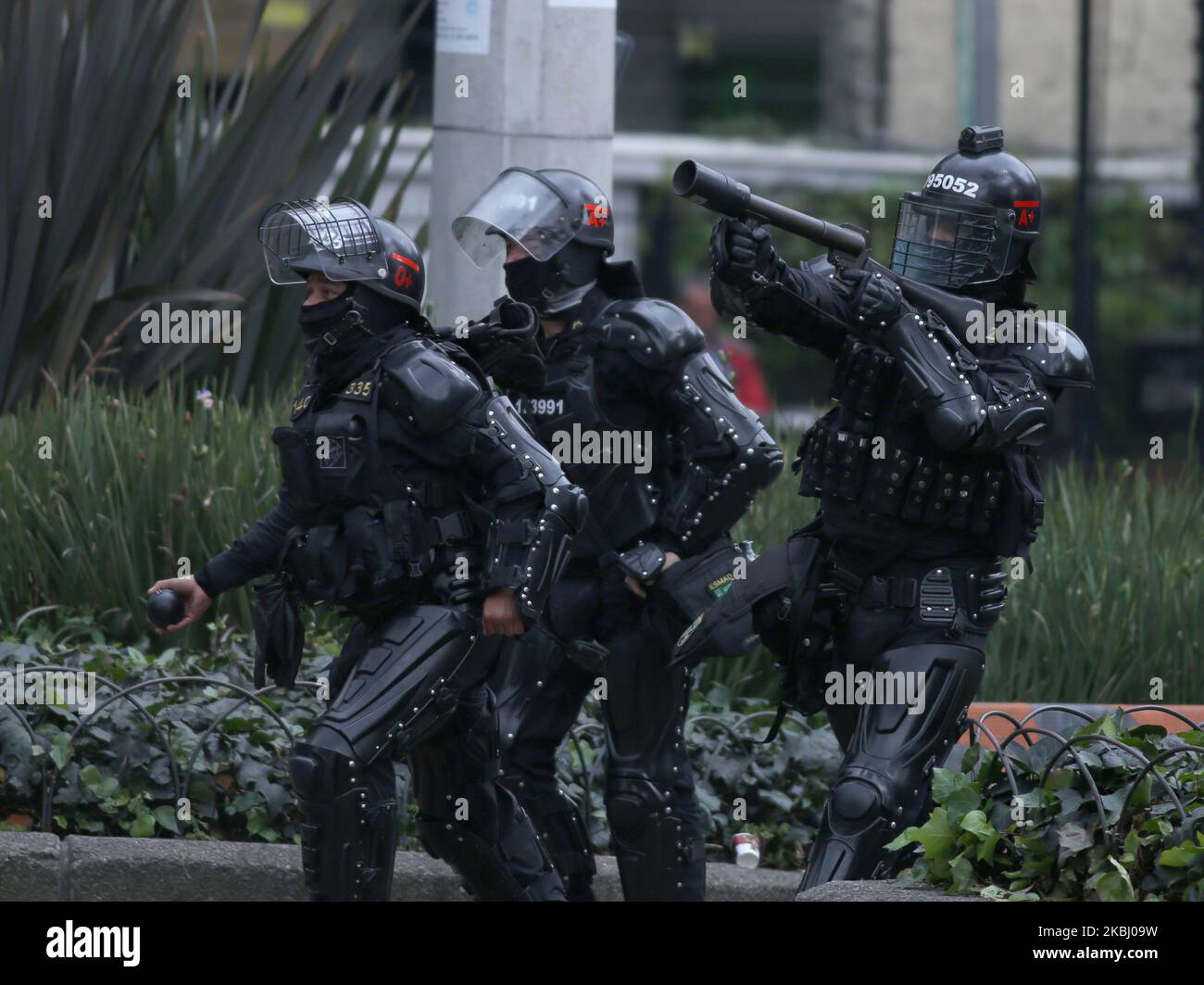 Some agents trying to disperse hooded men in celebration of the 21st ...