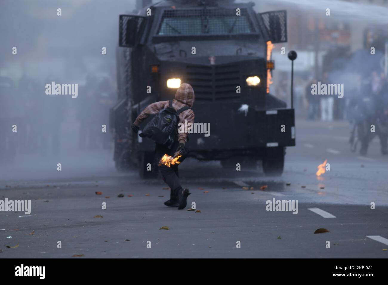 A person throws a bomb against the esmad tank in celebration of the ...