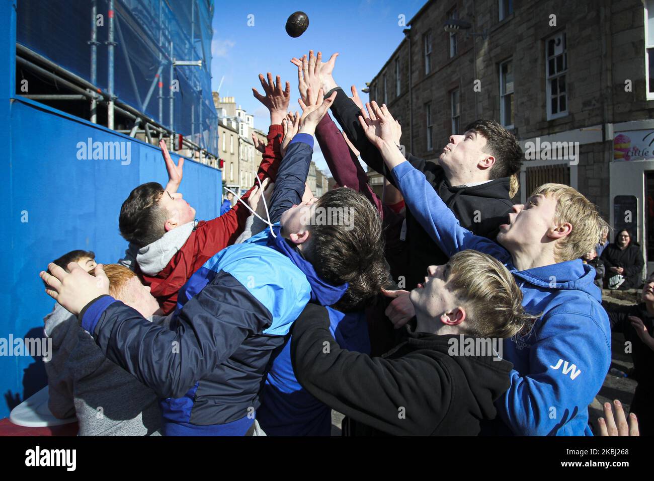 Boys chase after the leather ball during the annual game of hand ba ...