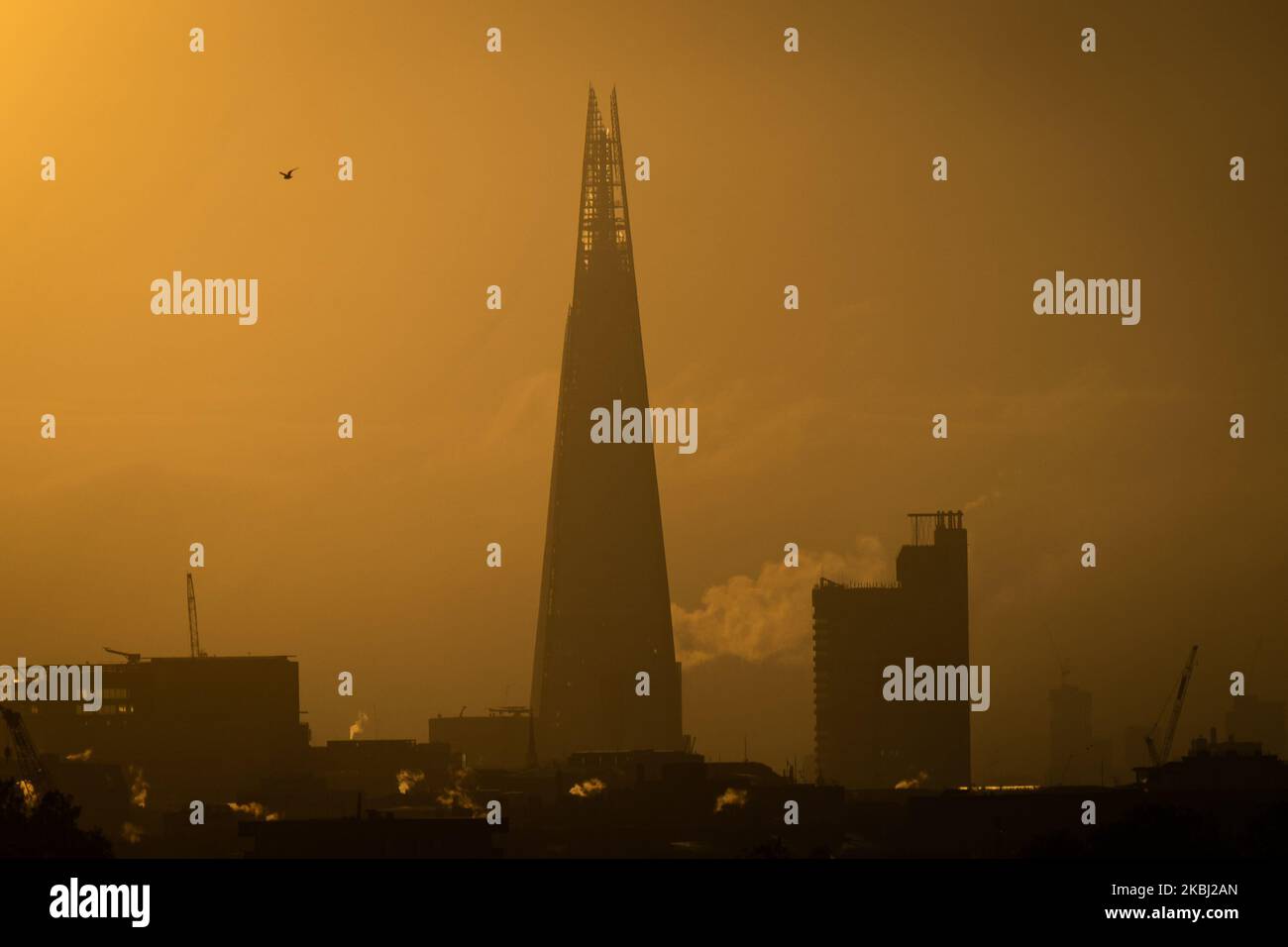 The sun rises behind the the Shard on the London skyline from Primrose ...