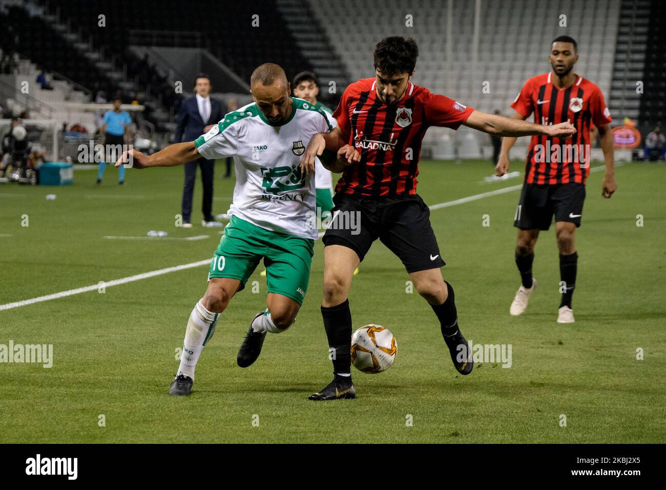 Nabil El Zhar of Al Ahli and Khalid Muftah of Al Rayyan tussle for the ...