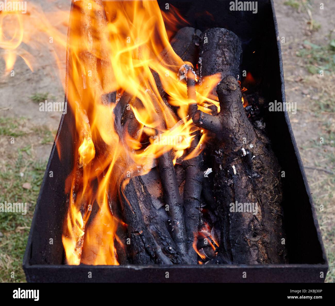 Burning red hot sparks fly from fire. Barbecue gril with glowing and ...