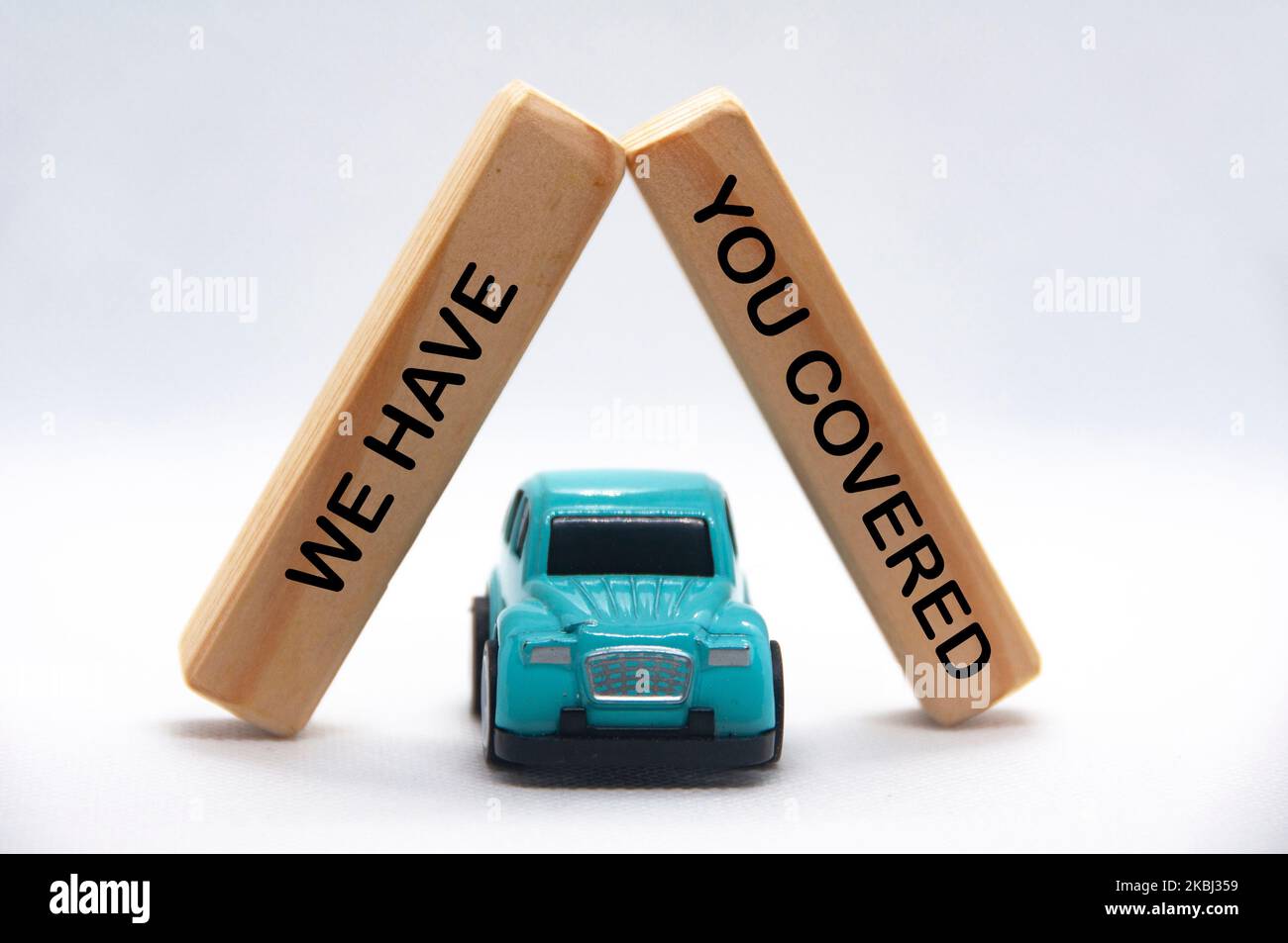 We have you covered text on wooden blocks with model car on white ...
