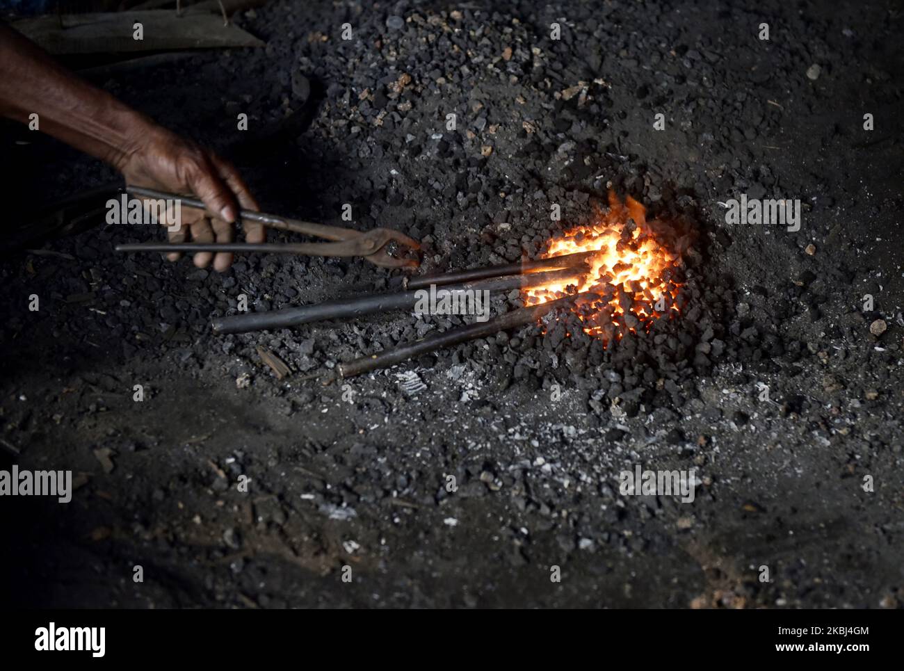 A labour works inside an iron tool workshop in Kolkata, India, 28 ...
