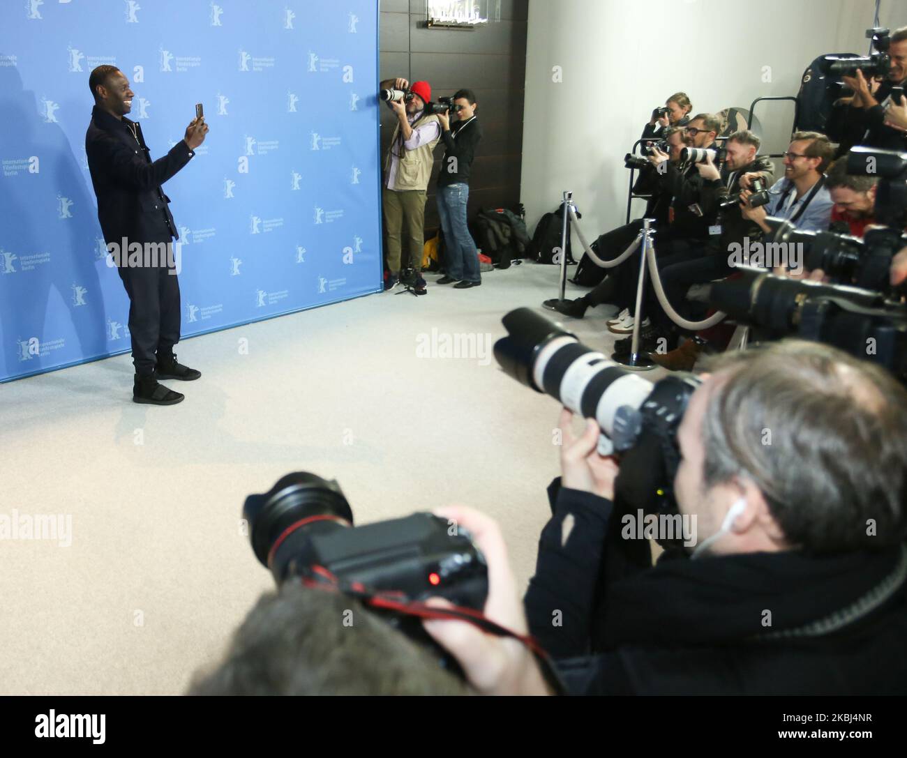 Omar Sy photographs press photographers while posing at the ''Police ...