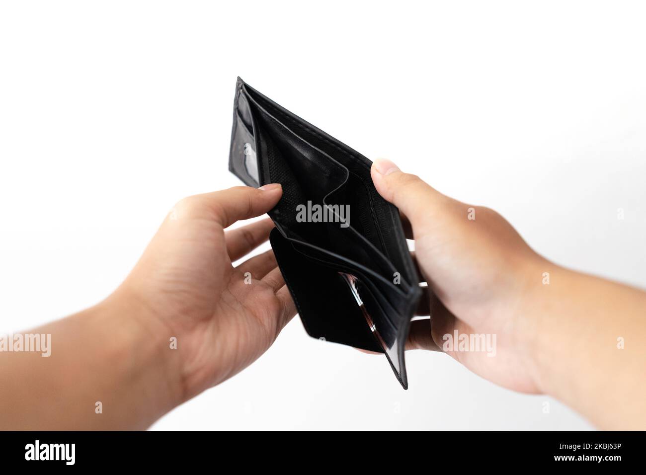 Hands hold a black empty wallet with no money inside Stock Photo - Alamy