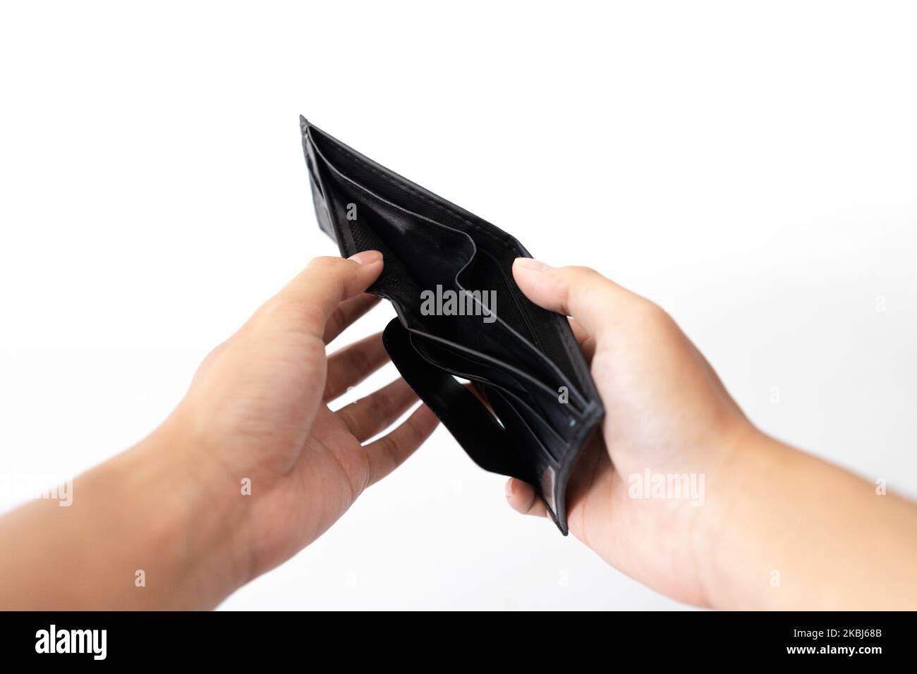 Hands hold a black empty wallet with no money inside Stock Photo - Alamy