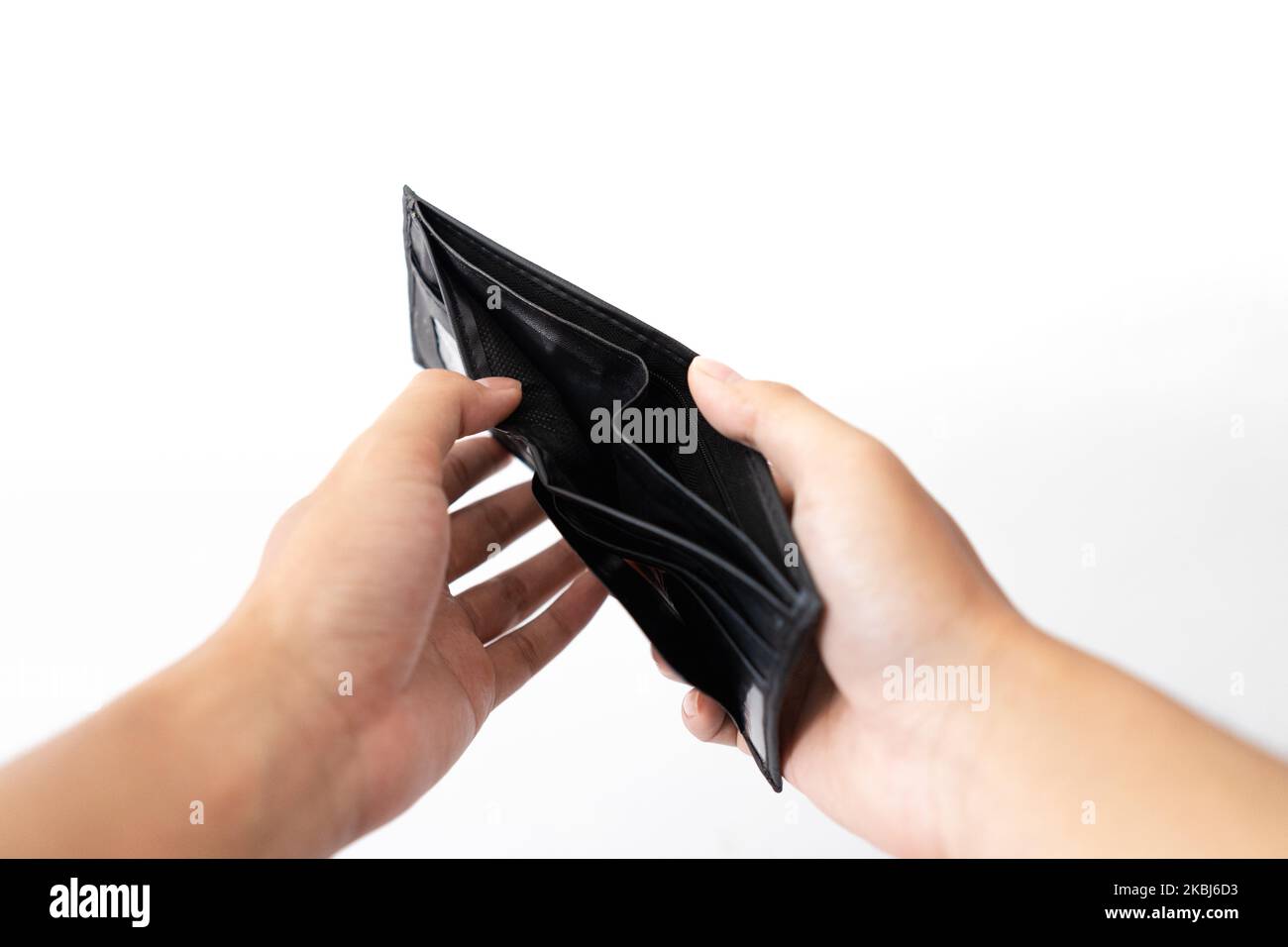 Hands hold a black empty wallet with no money inside Stock Photo - Alamy