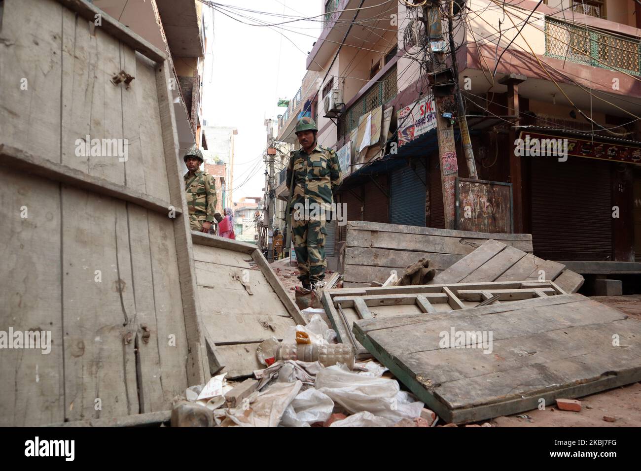 An Indian paramillitary trooper stands min a riot hit area Mustafabad ...