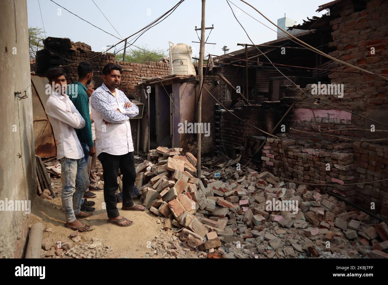 Muslim Residents stand inside a damaged residential house after a mob ...