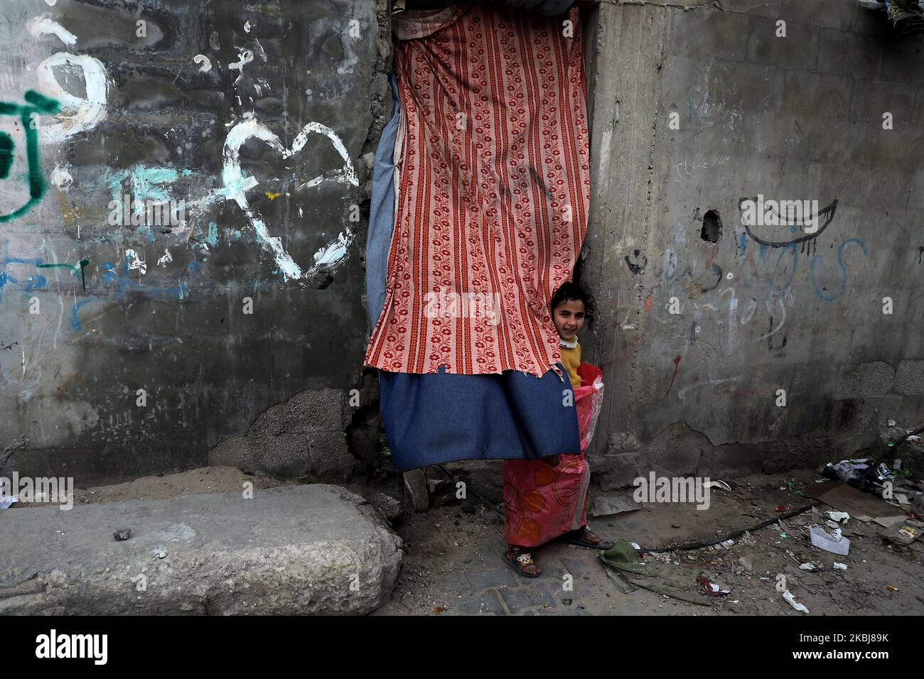 A Palestinian refugee plays outside her family home at al-shati ...