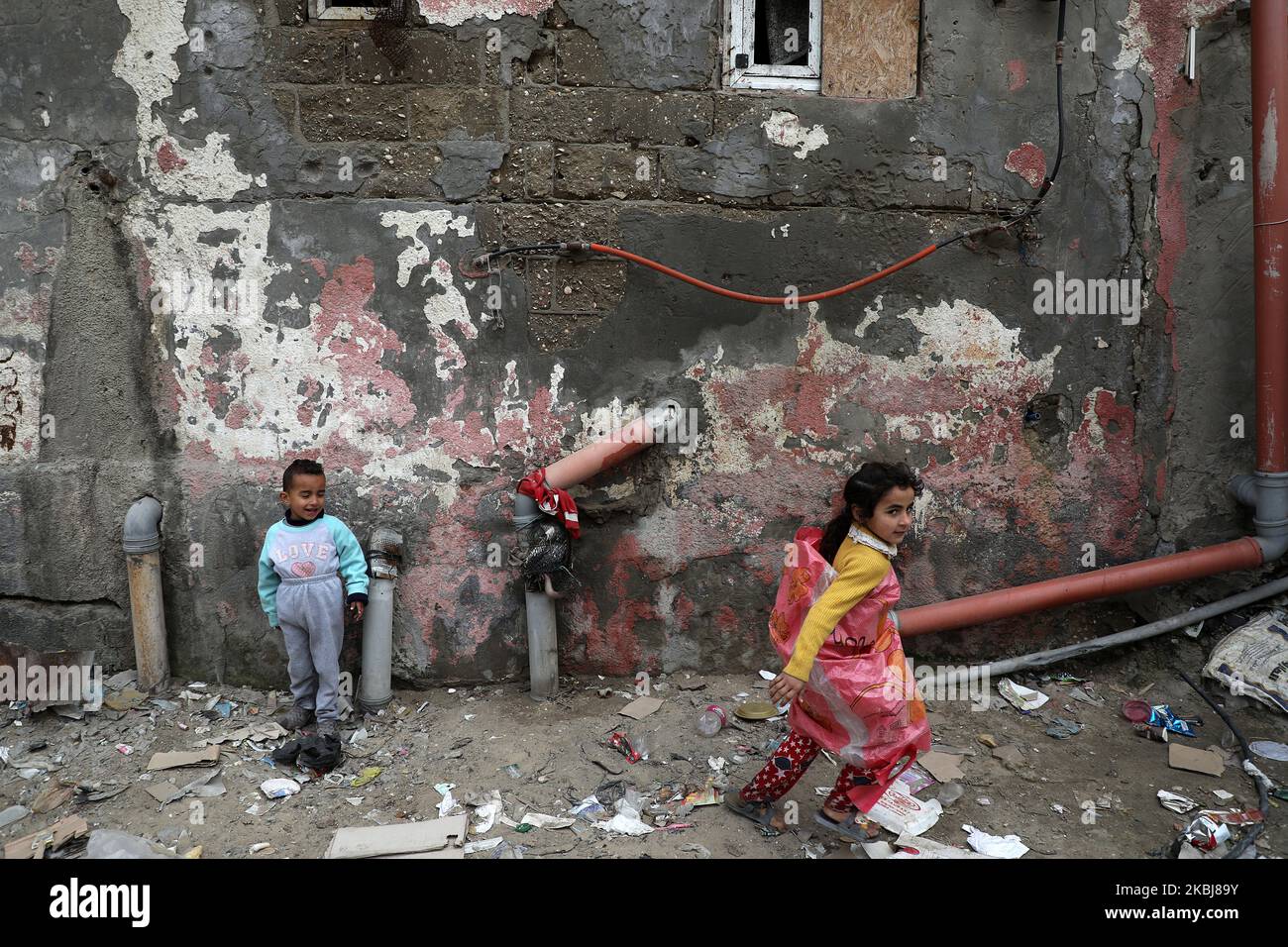 Palestinian refugees play outside their family home at al-shati ...