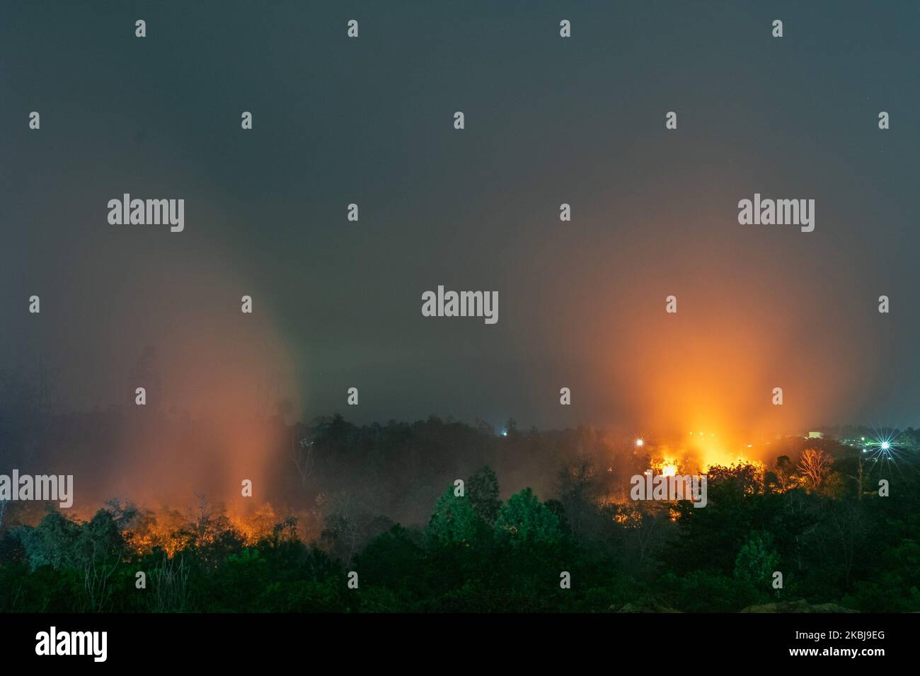 A long-exposure photograph shows a Forest fire at Rumbai Pesisir ...