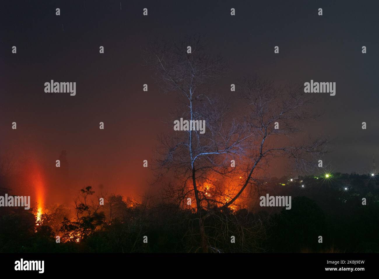 A long-exposure photograph shows a Forest fire at Rumbai Pesisir ...